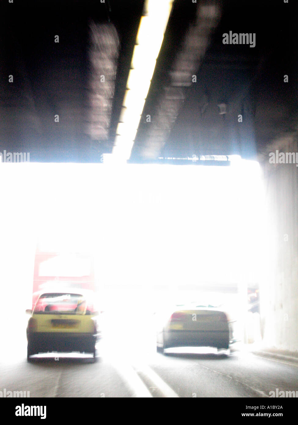 Light at the end of the tunnel concept traffic emerging from tunnel ...