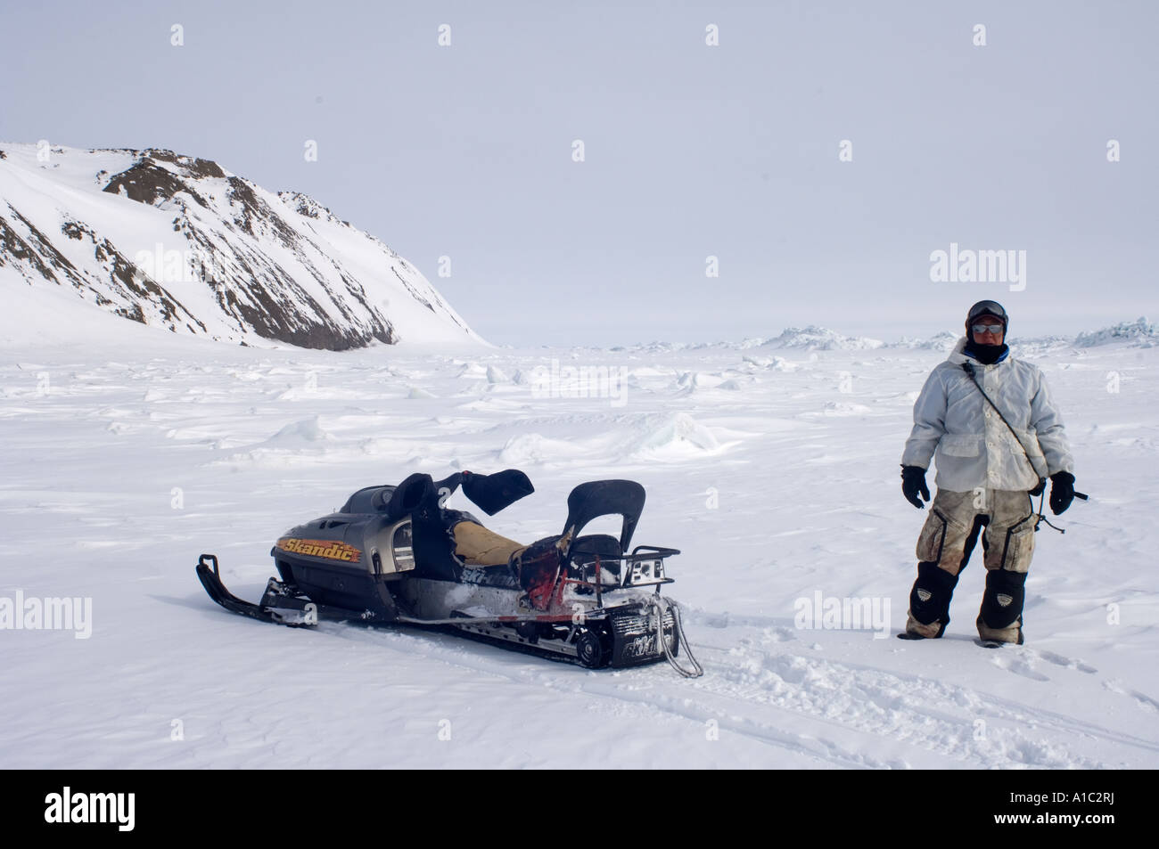 inupiat hunter and guide on the frozen Arctic ocean off Herschel Island ...