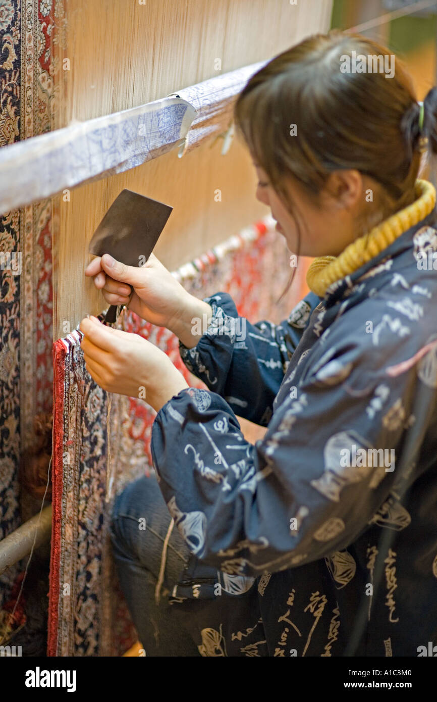 CHINA XI'AN Female Chinese artisan weaving an oriental rug on a ...