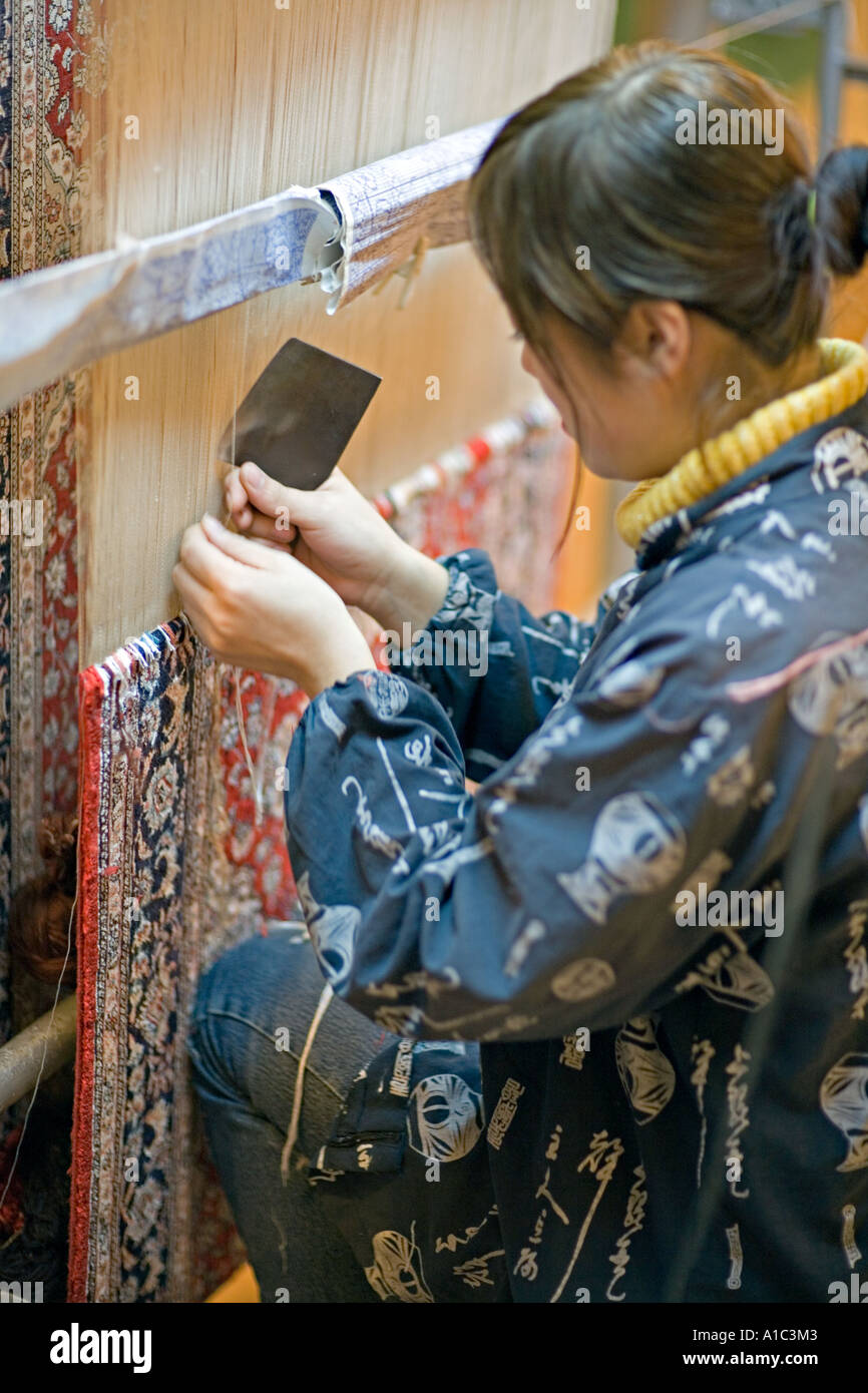 CHINA XI'AN Female Chinese artisan weaving an oriental rug on a ...