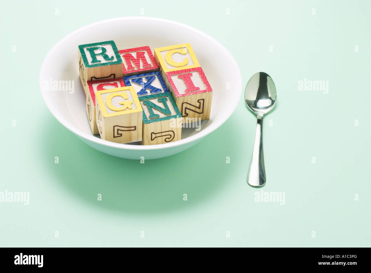 Alphabet Blocks in Bowl with Spoon Stock Photo - Alamy