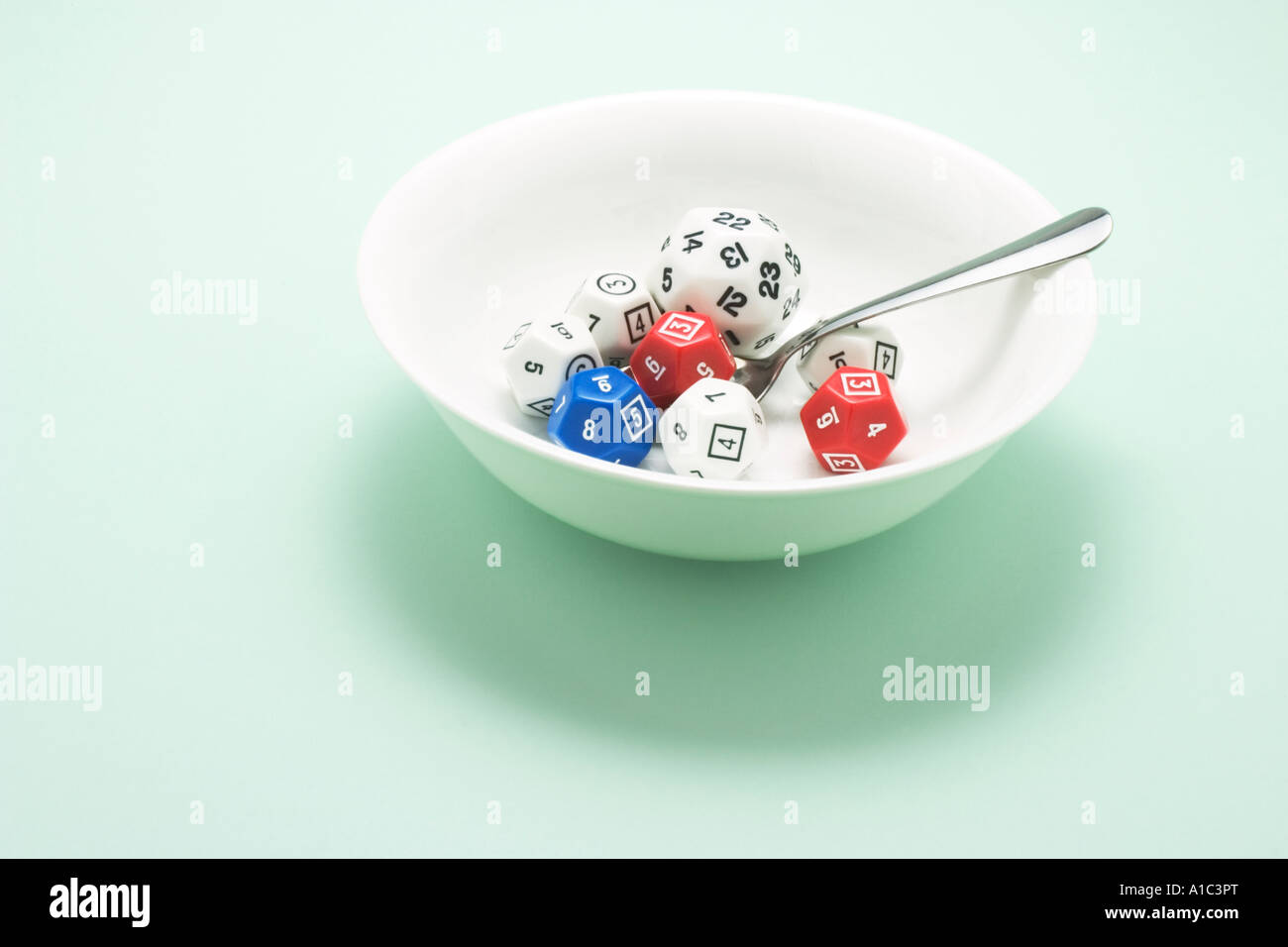Dice and Spoon in Bowl Stock Photo - Alamy