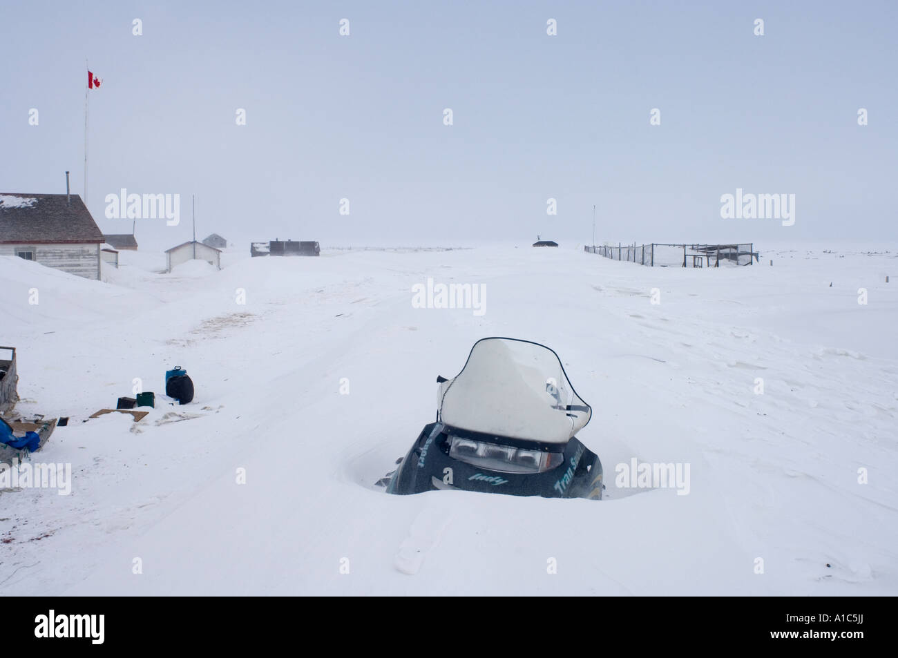 snow machine buried in snow after a storm Herschel Island off the ...