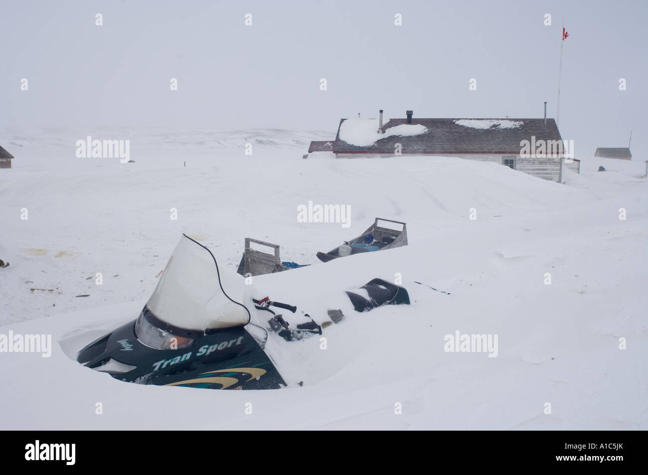 snow machine buried in snow after a storm Herschel Island off the ...