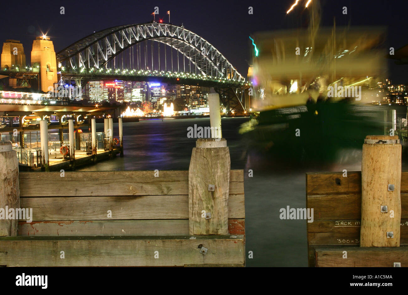 Sydney Harbour ferry docking at Circular Quay against Sydney Harbour ...