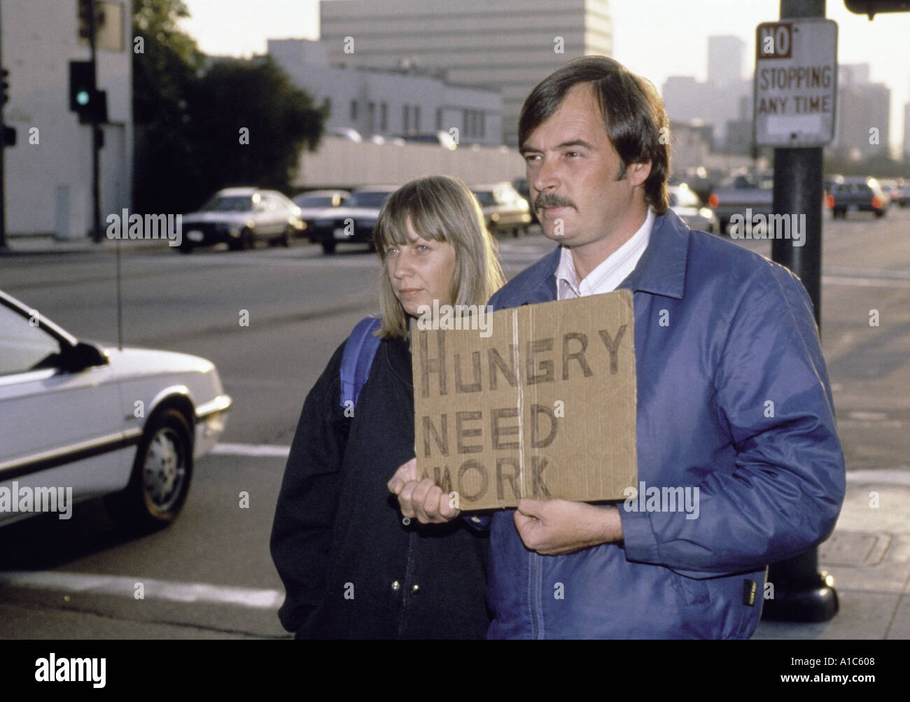 Unemployed but not homeless couple hold sign reading will work for food ...