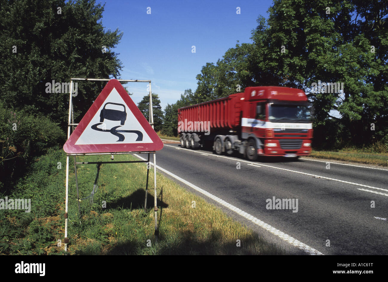 lorry passing warning sign of slippery road surface ahead leeds ...