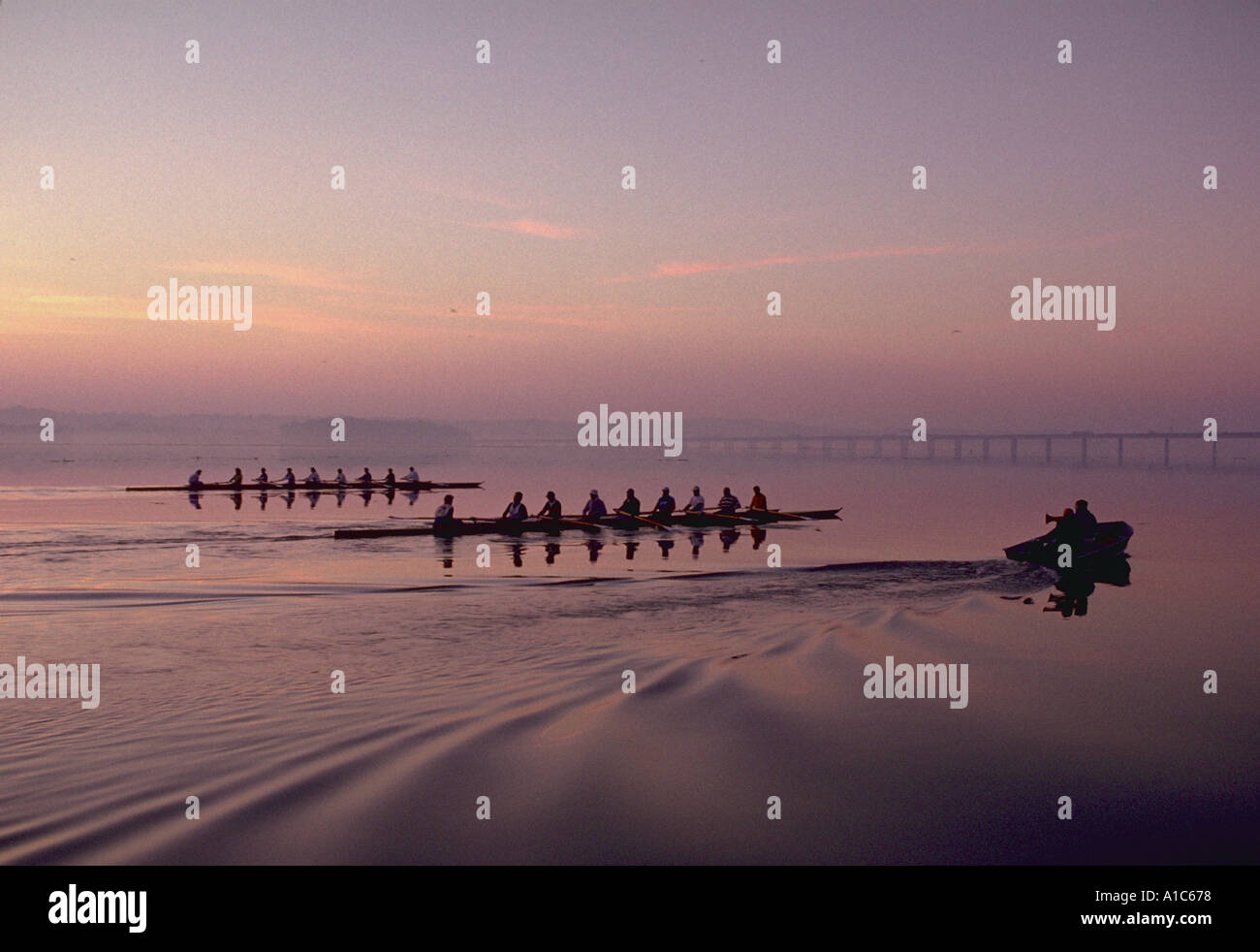 Rowing two 8 person boats 8 man shells and one small coach or starter's ...