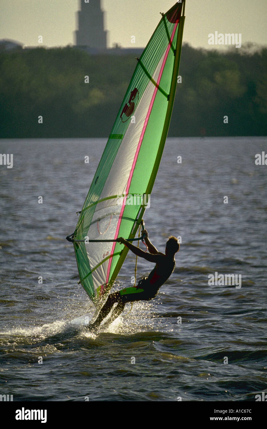 Sailboarding action shot with man and colorful sail Also called ...