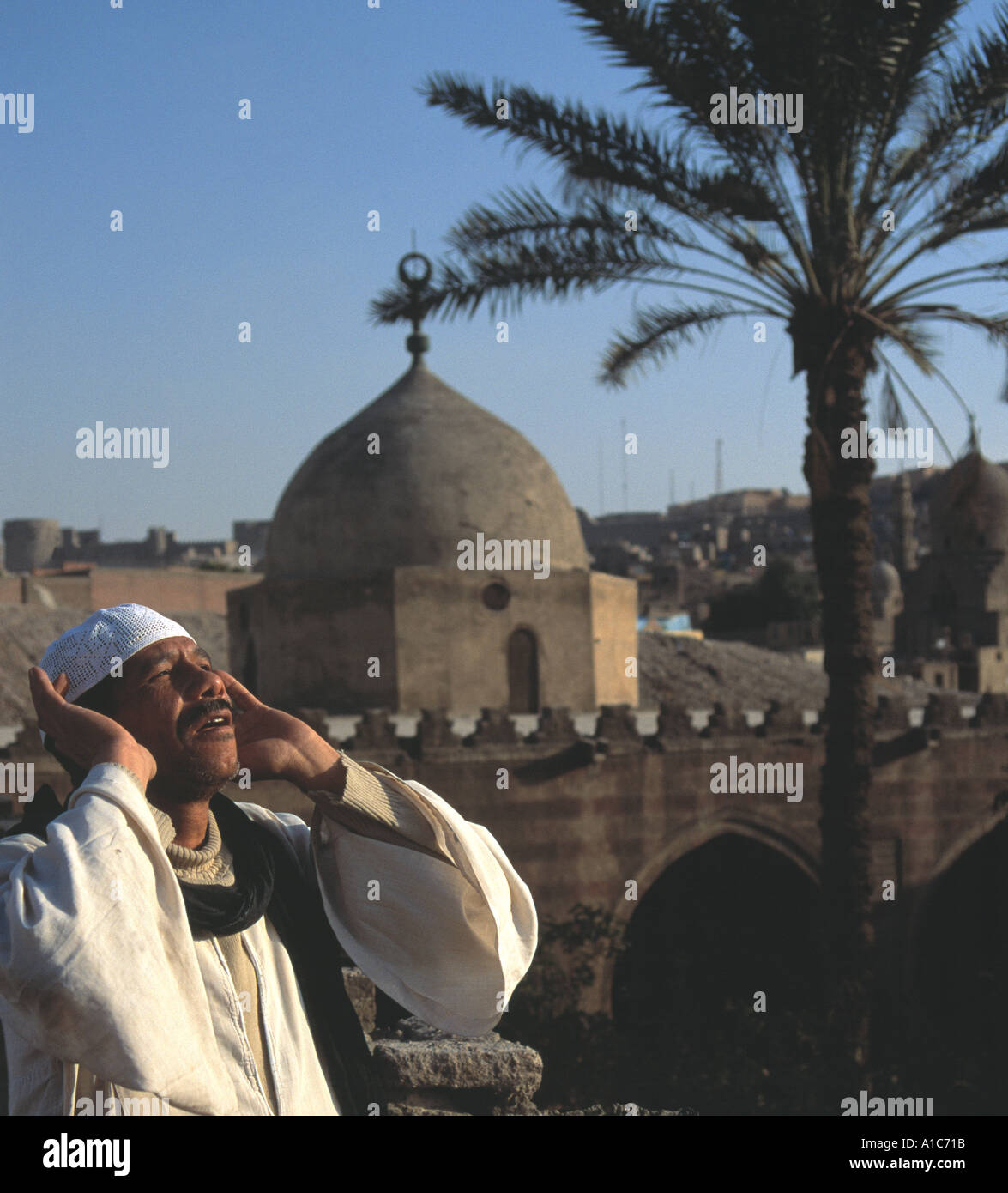 Muezzin making the adhan or invitation to prayer from a mosque in Cairo ...