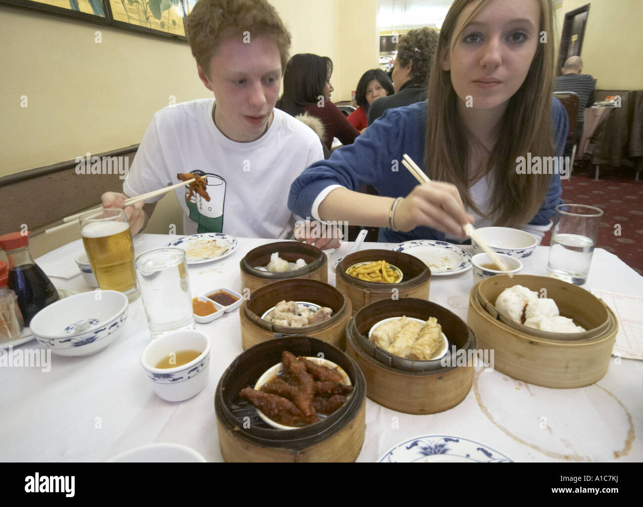 a teenage couple aged 16 on day trip to London eating Dim Sum with ...