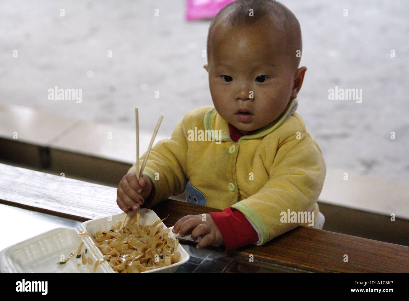 Trying to use chopsticks hi-res stock photography and images - Alamy