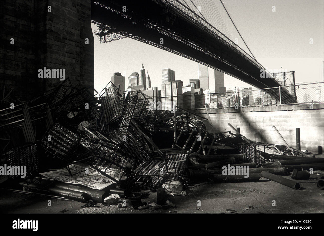 Metal garbage pile below Brooklyn Bridge and Lower Manhattan skyline ...