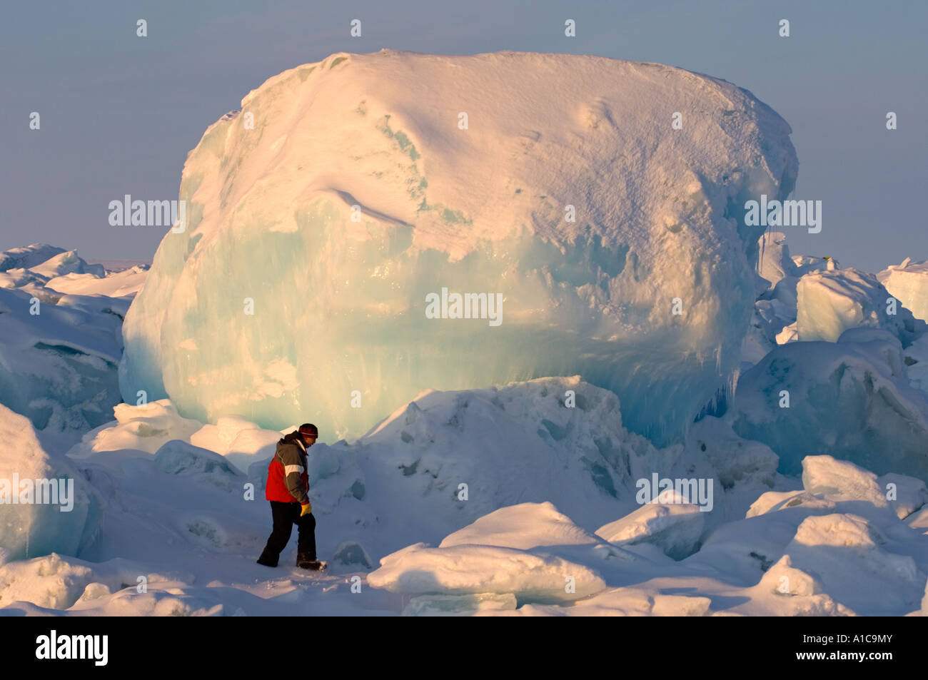 Stacy Hopson walks by a giant ice ball on the frozen Chukchi Sea during ...