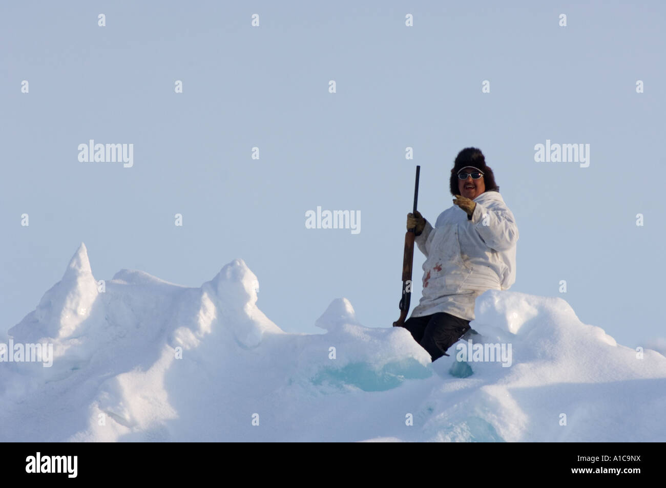 inupiat duck hunter at the edge of a lead on the frozen Chukchi Sea off ...