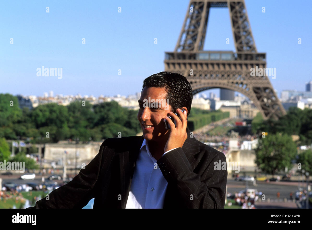 France Communications with man with cell phone in front of Eiffel Tower ...