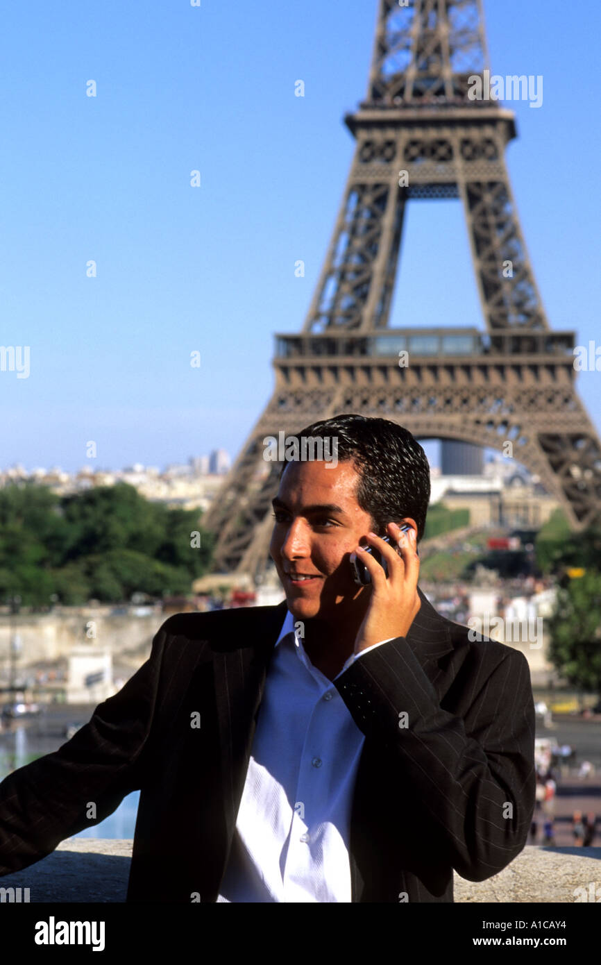 France Communications with man with cell phone in front of Eiffel Tower ...