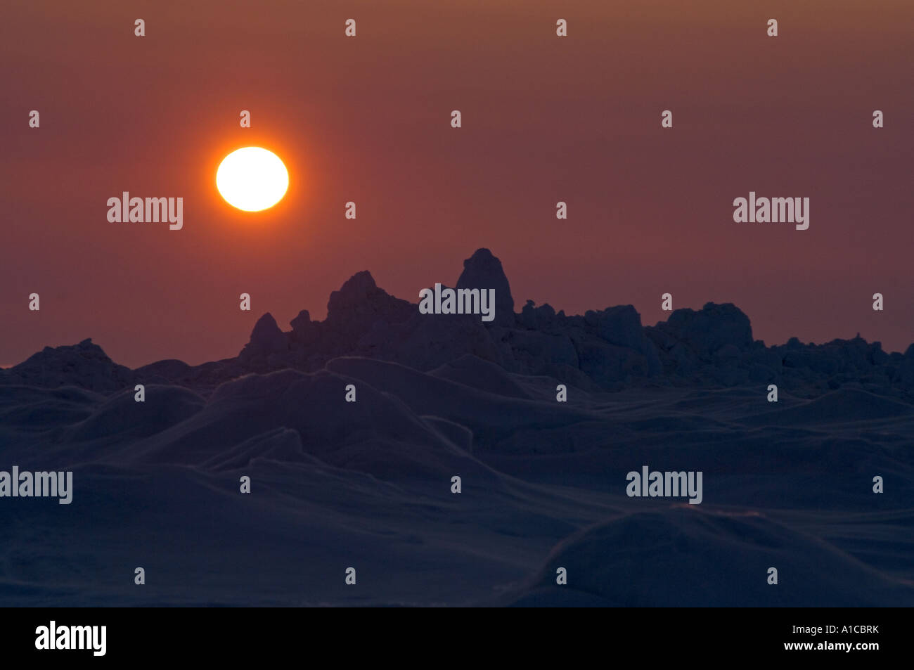 sunset over jumbled ice on the frozen Chuckchi Sea off Point Barrow ...