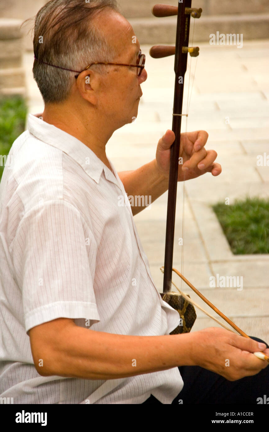 Old Chinese Musician practicing in the early morning Stock Photo - Alamy