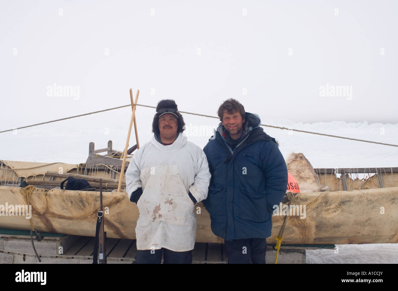 inupiat duck hunter and photographer with skin boat on the frozen ...