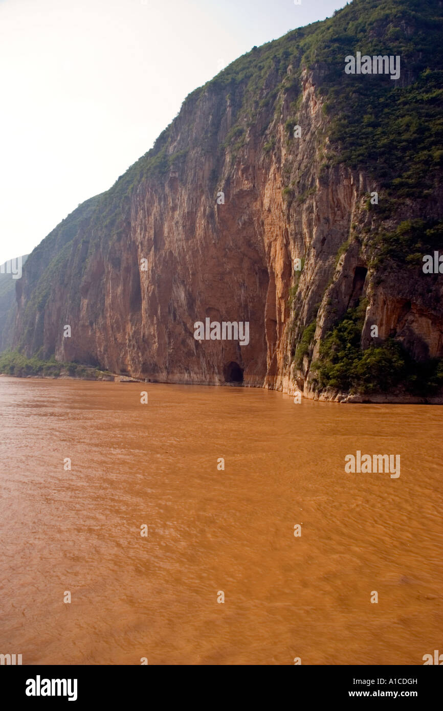 Small cave at the bottom of a vertical cliff on the Banks of the Yangzi ...