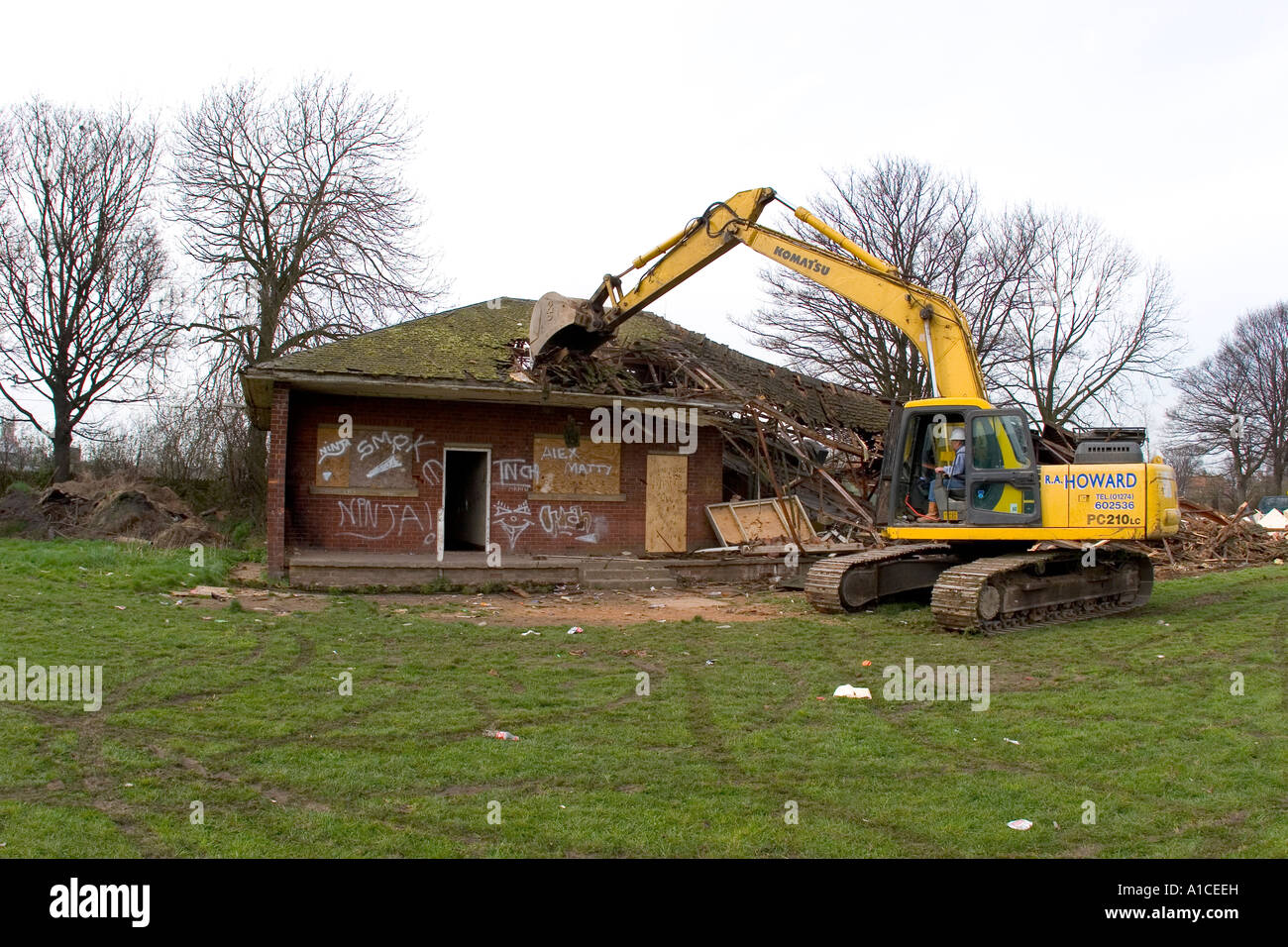 An old derelict building being demolished by a digger Stock Photo - Alamy