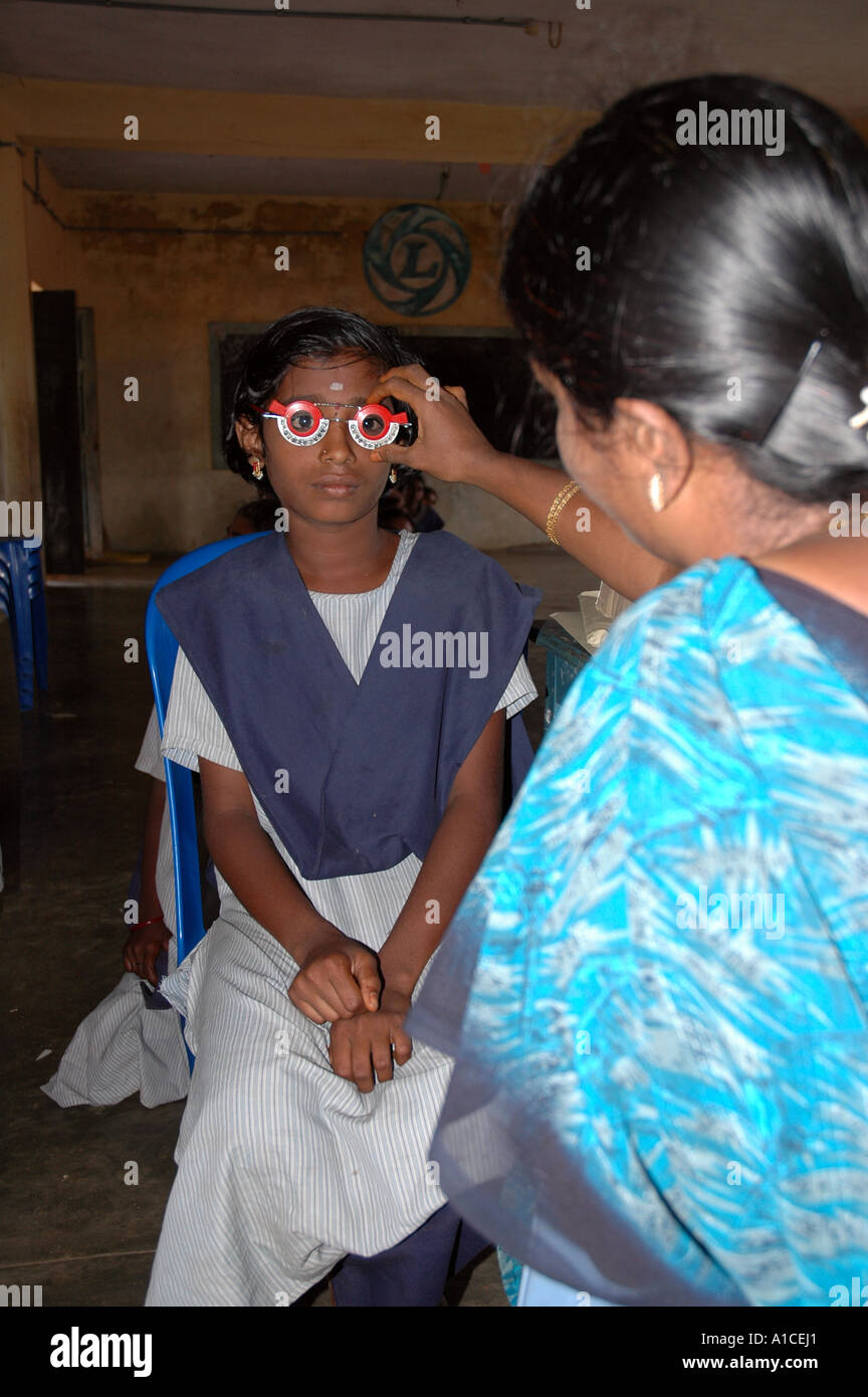 A young girl has an eye test at a screening camp in her school in India ...