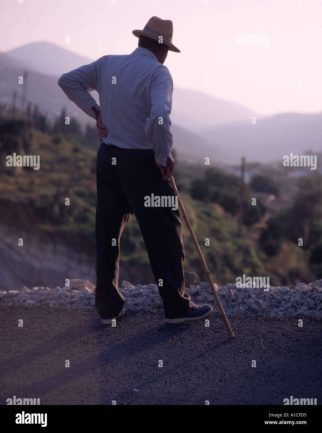 An old man on road to Competa looking out over the landscape Andalucia ...