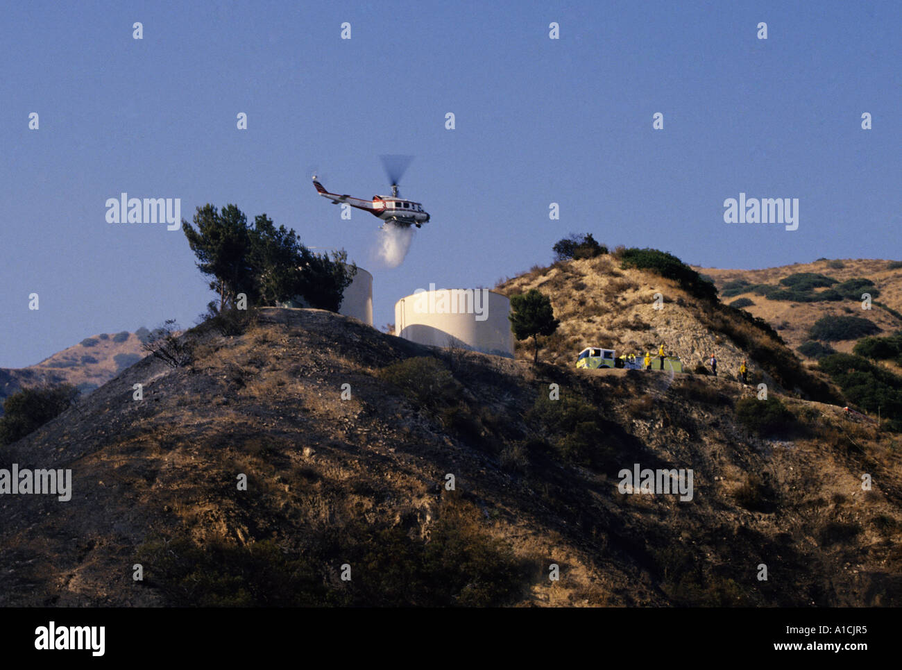 Helicopter dropping fire retardant on brush fire in Burbank, CA Stock ...