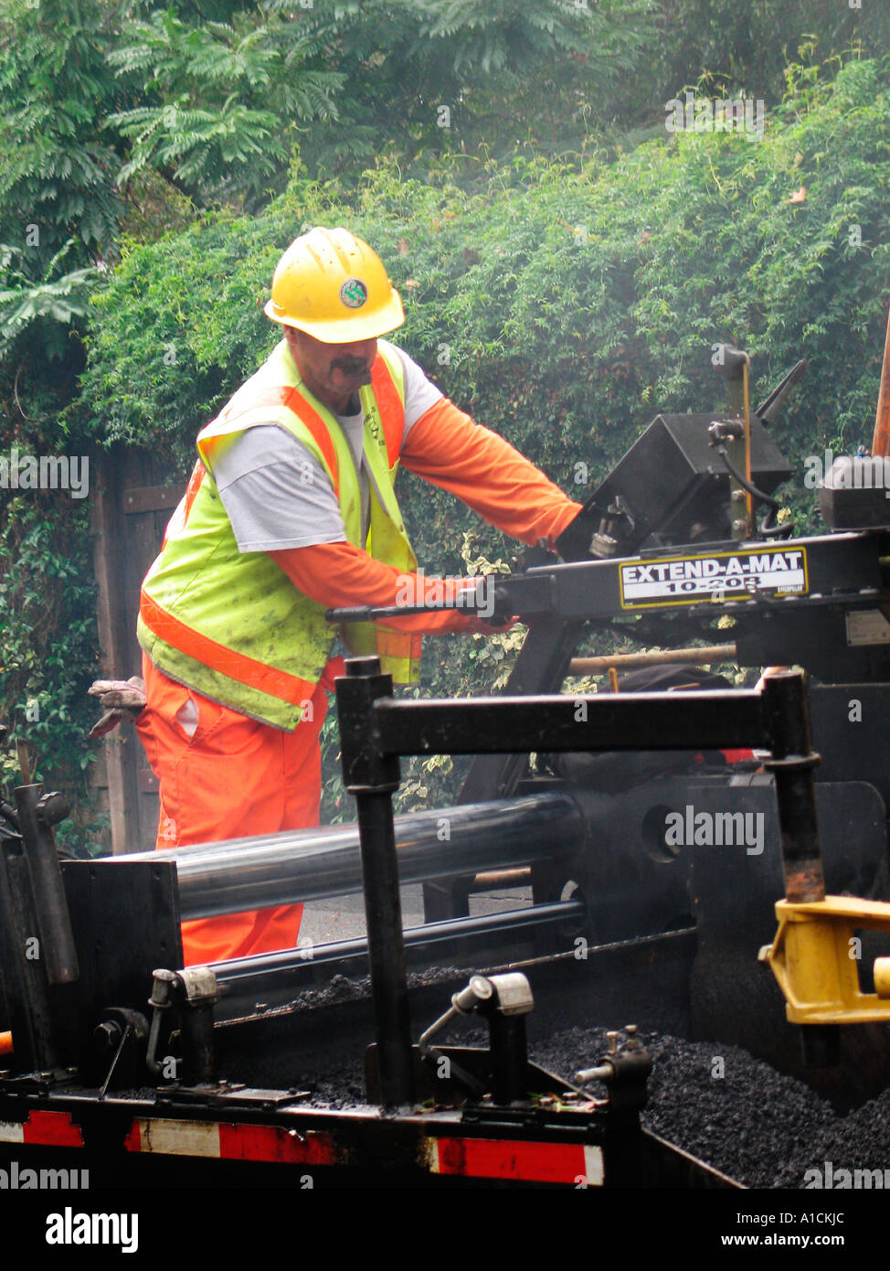 Road Worker repaving asphalt road Stock Photo - Alamy