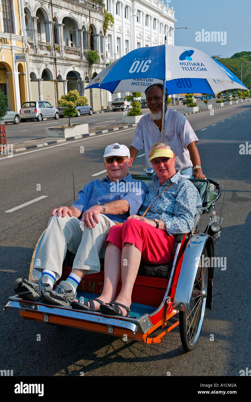 Visitors take trishaw ride Georgetown Penang Malaysia Stock Photo - Alamy