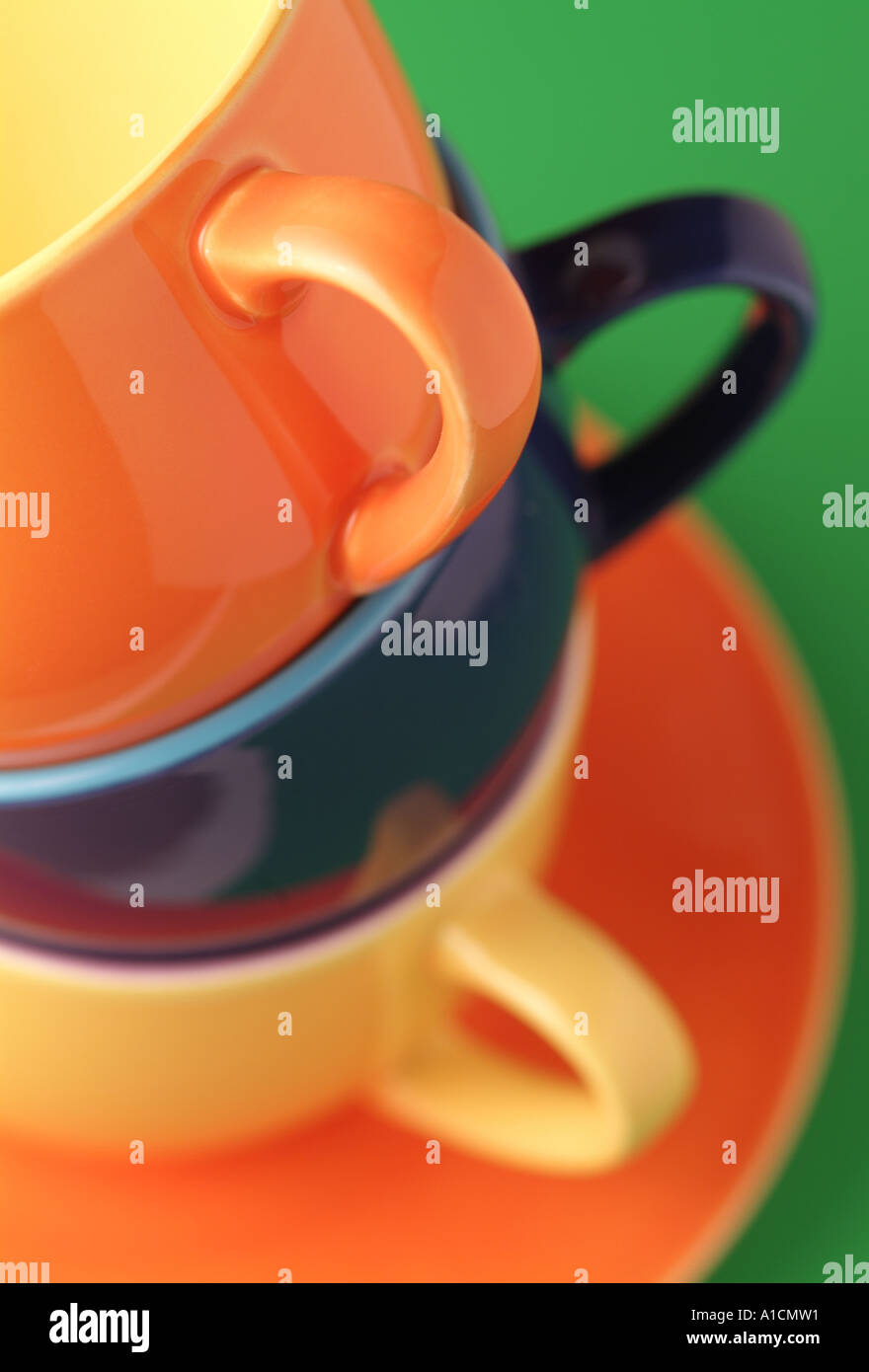 coloured coffee cups on green background Stock Photo - Alamy