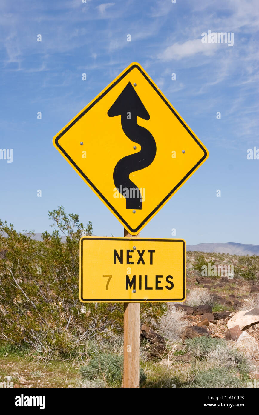 Road sign indicating curves ahead on Highway 190 in Death Valley ...