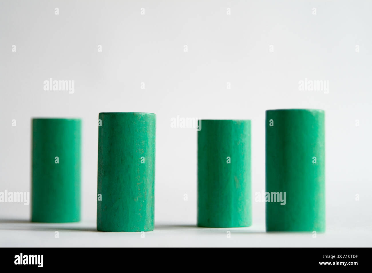 four green cylindrical toy wooden blocks Stock Photo - Alamy