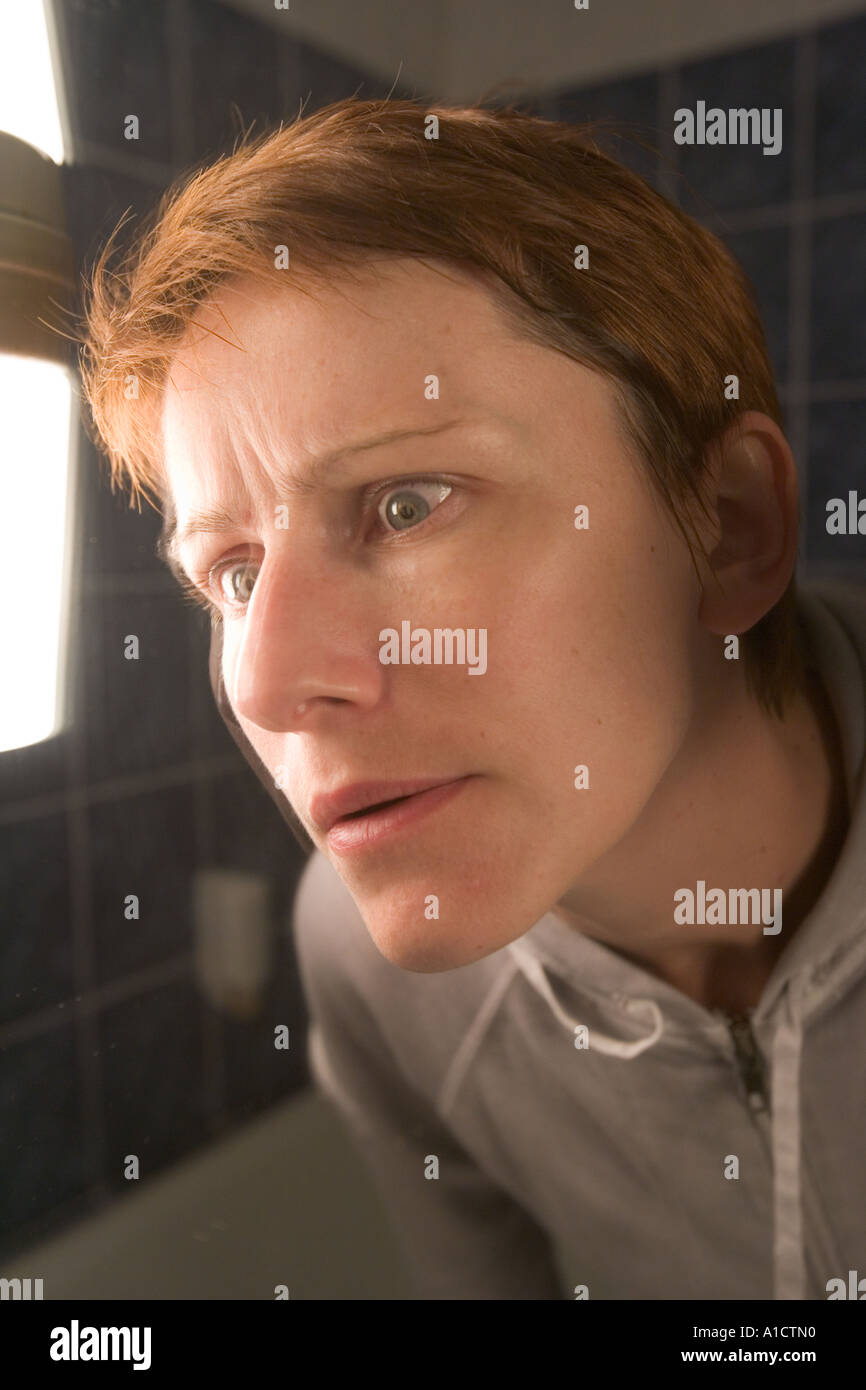 Close-up of the face of a woman gazing shocked Stock Photo - Alamy