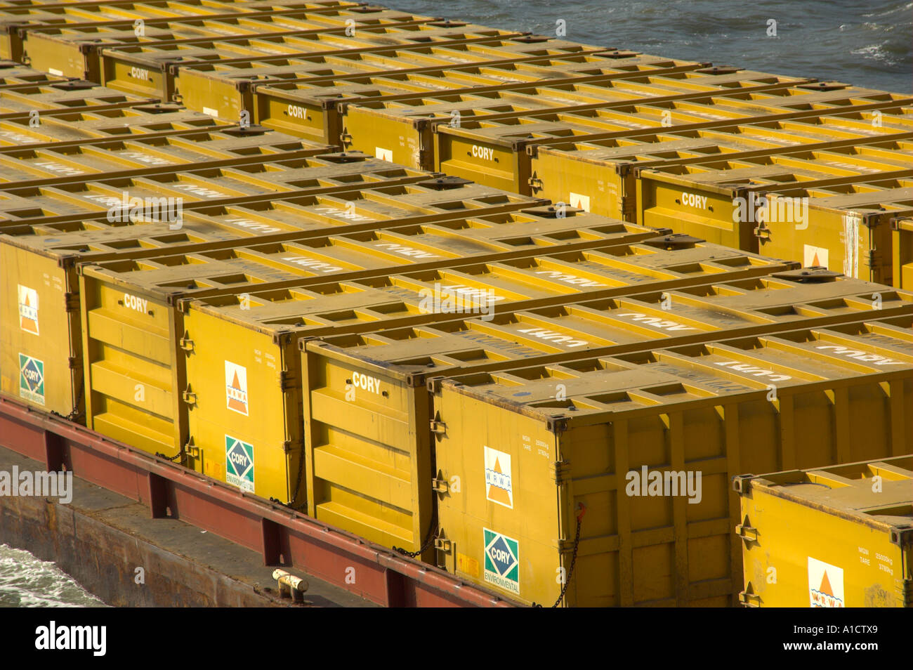 UK England London shipping containers on a barge on the river thames ...