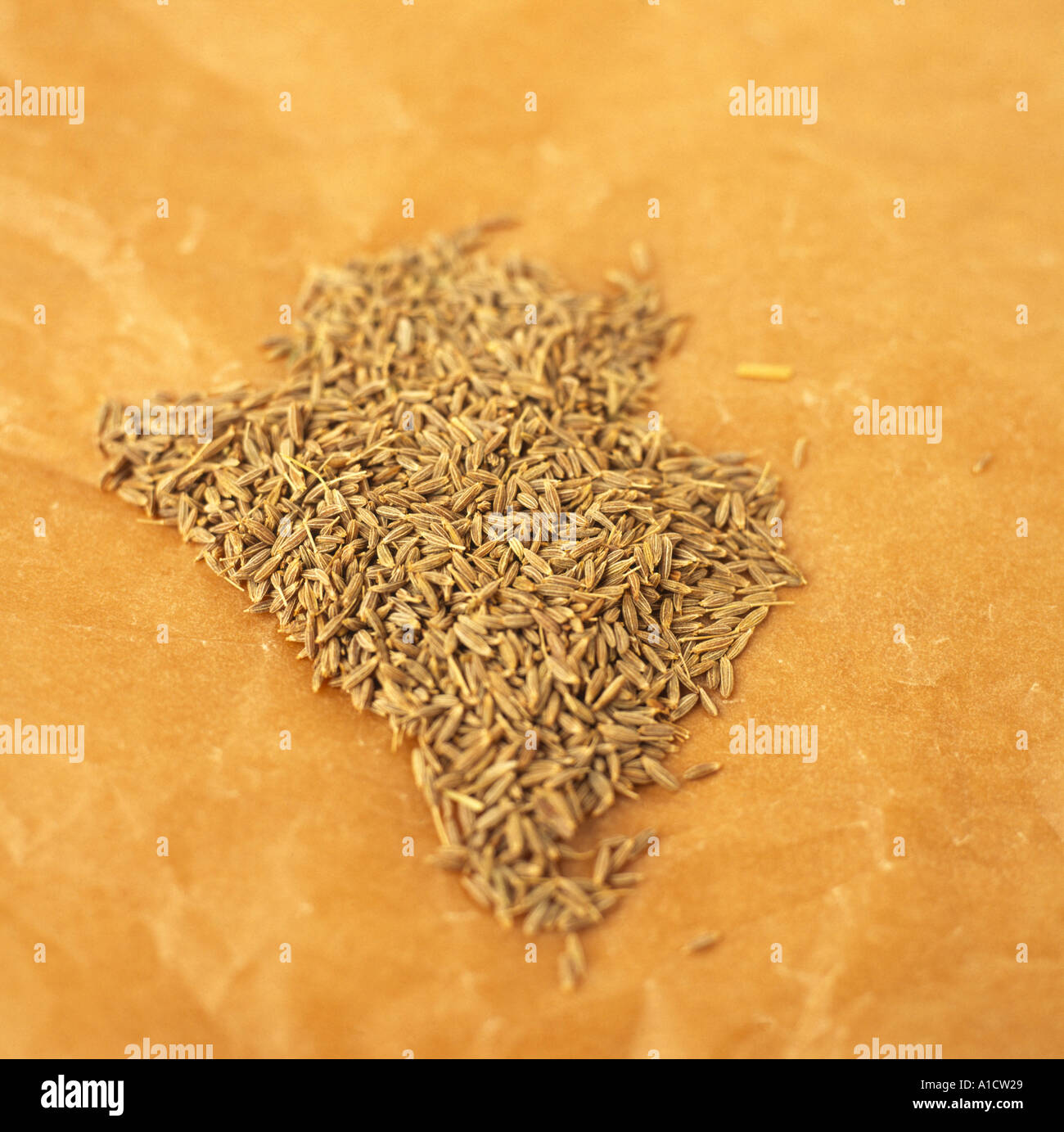 Cumin seeds on brown paper Stock Photo - Alamy