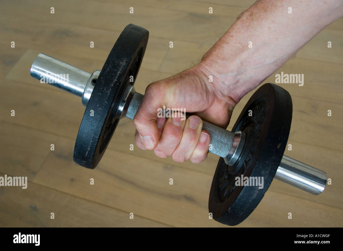 dumbell being lifted in one hand Stock Photo - Alamy