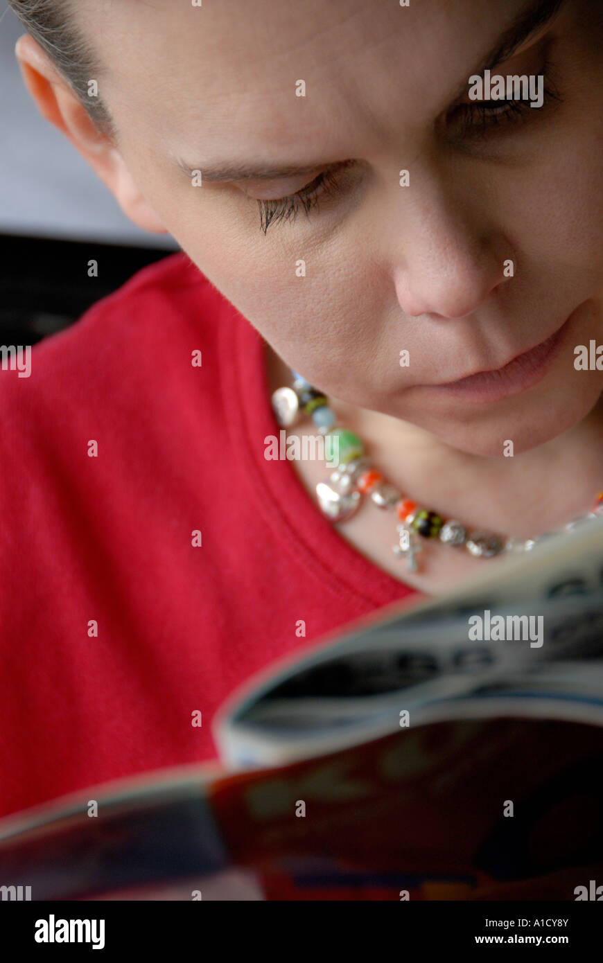 woman casually reading newspaper Stock Photo - Alamy