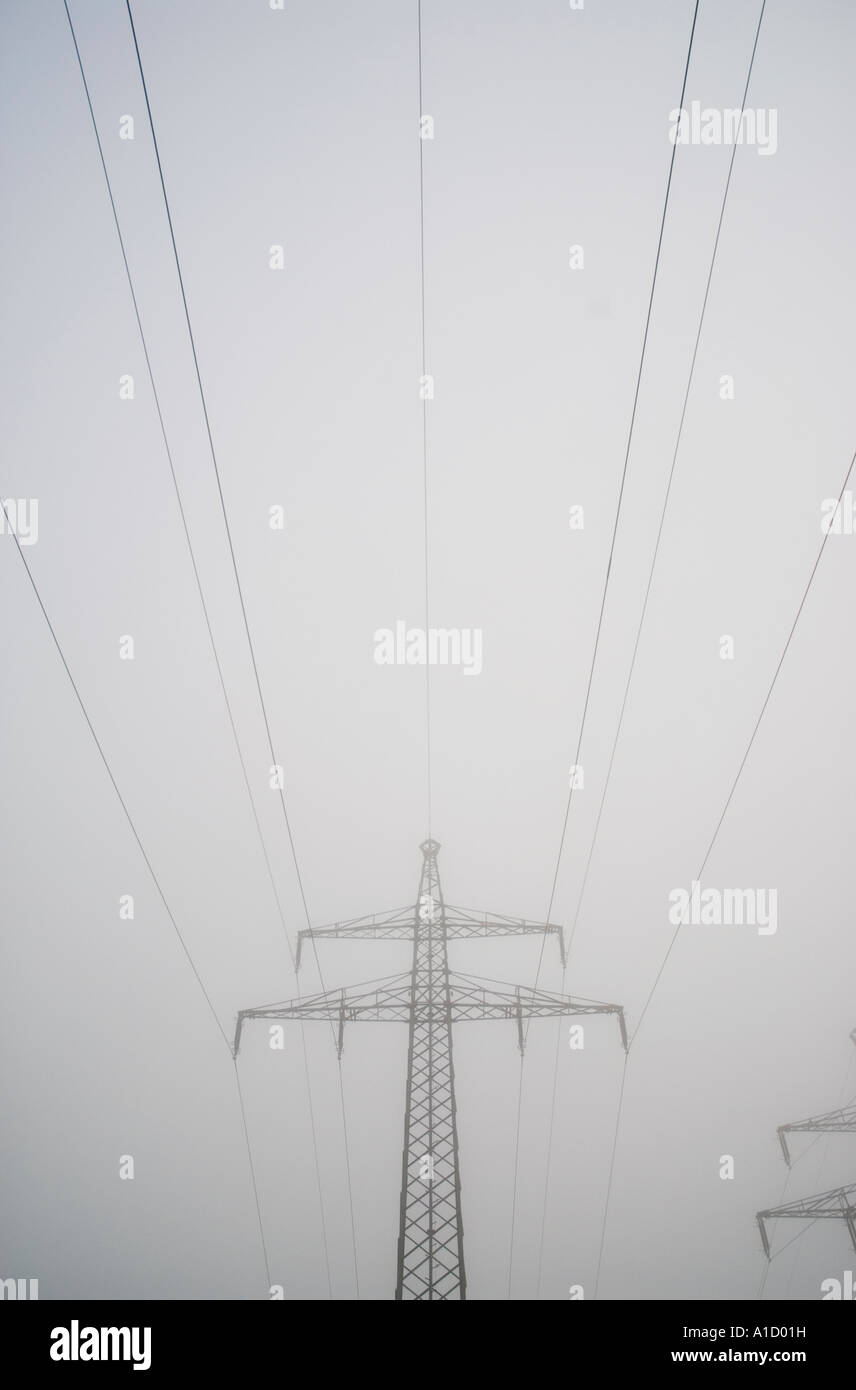 Electrical power lines vanish into dense fog Stock Photo - Alamy