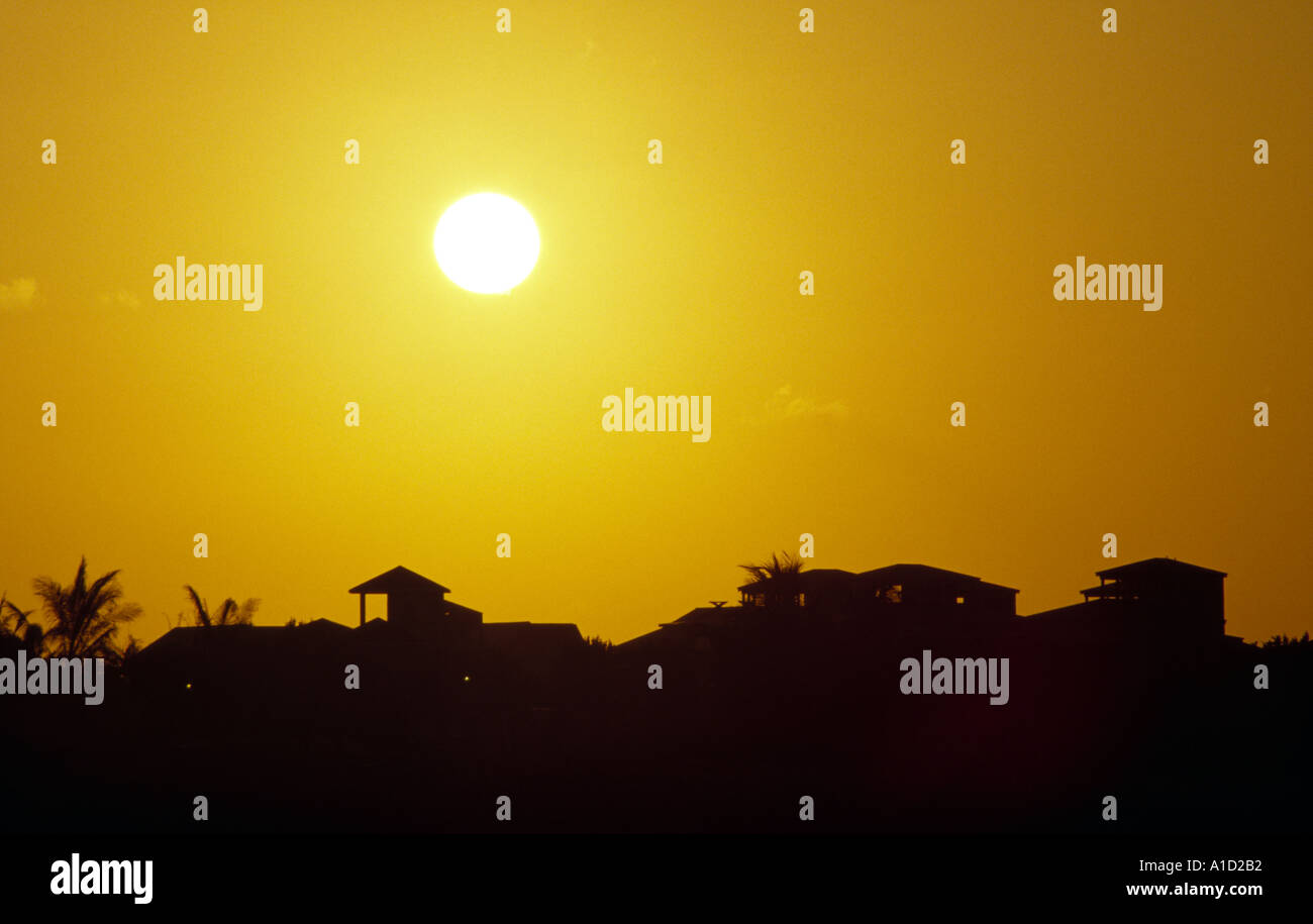 Sunset on island with houses Stock Photo - Alamy