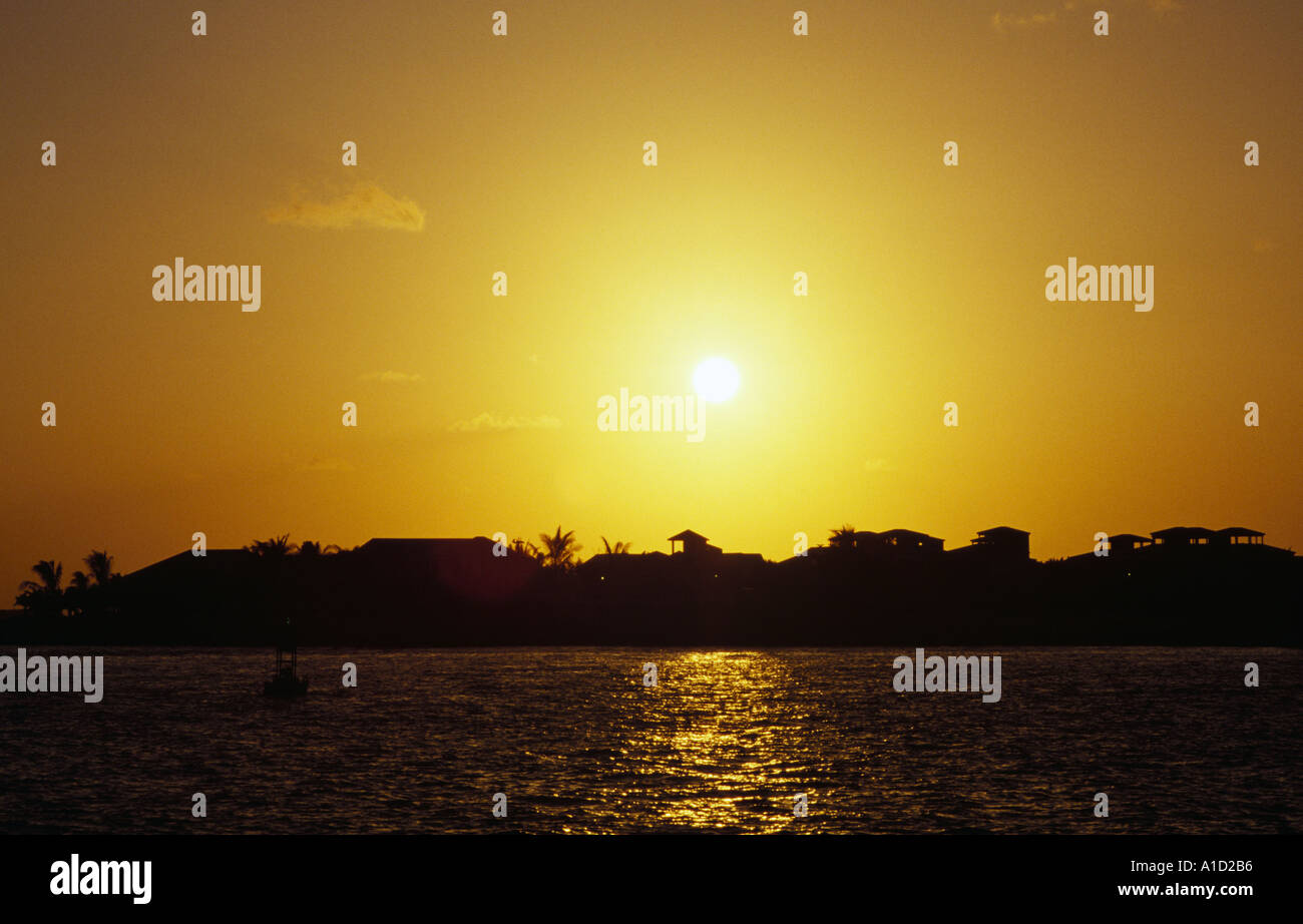 Sunset on island with houses Stock Photo - Alamy
