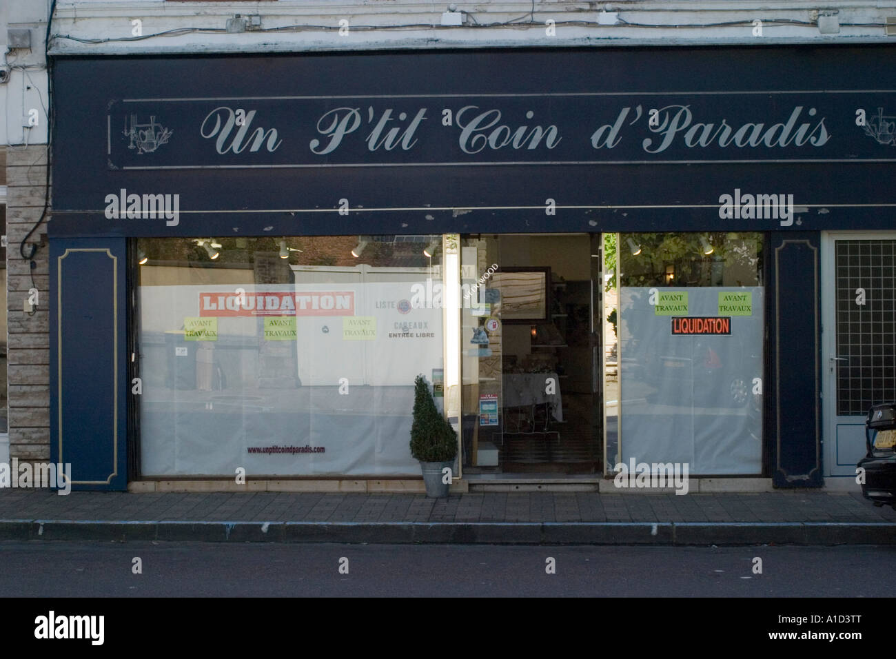 Exterior of shop with closing down sale windows papered over Hesdin Pas ...