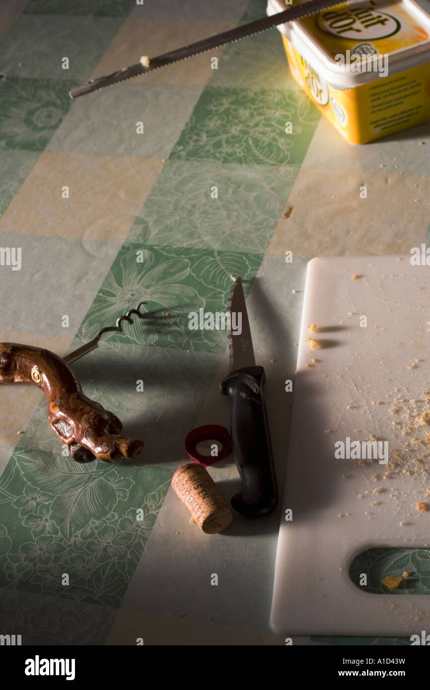 Corkscrew knife and chopping board on traditional oilcloth on kitchen ...