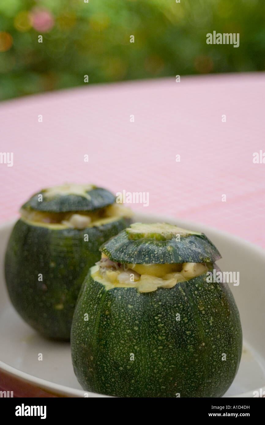Stuffed courgettes in glazed dish prepared and ready for cooking in ...