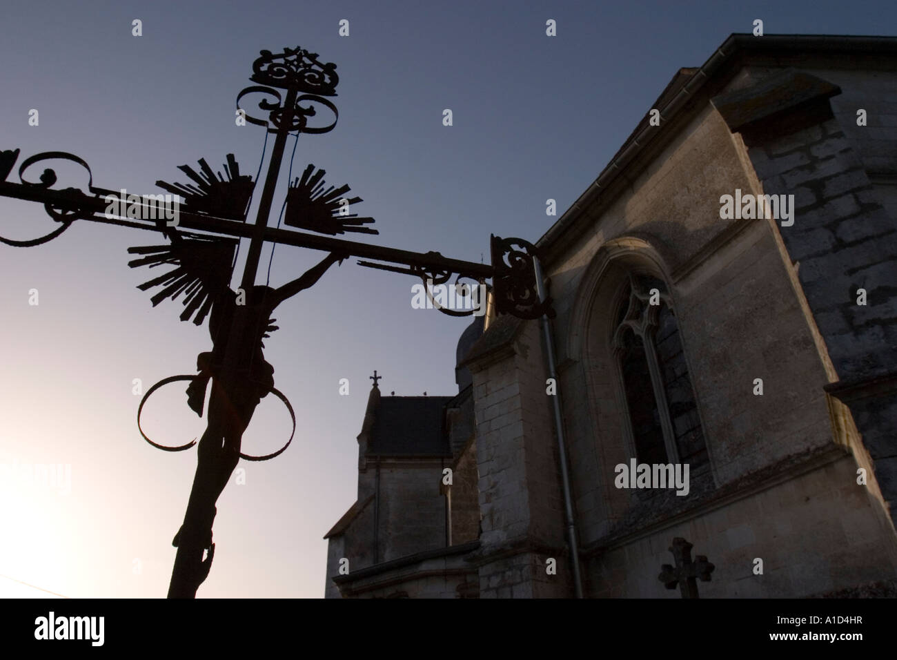 Corroded iron crucifix over grave in churchyard cemetry with figure of ...