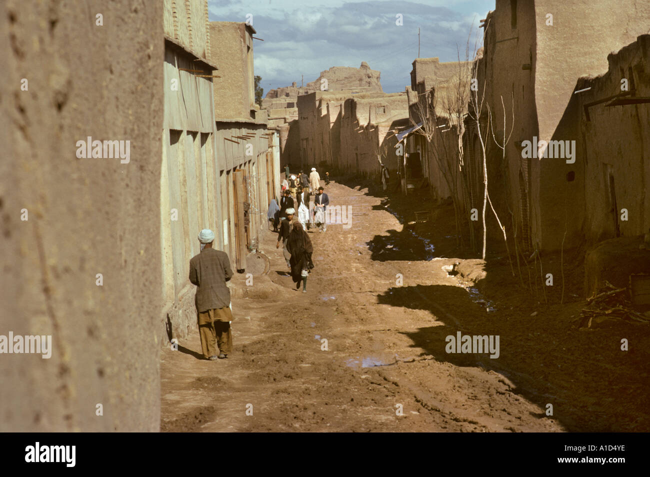 back street mud wall walled road man men going to mosk turban house ...