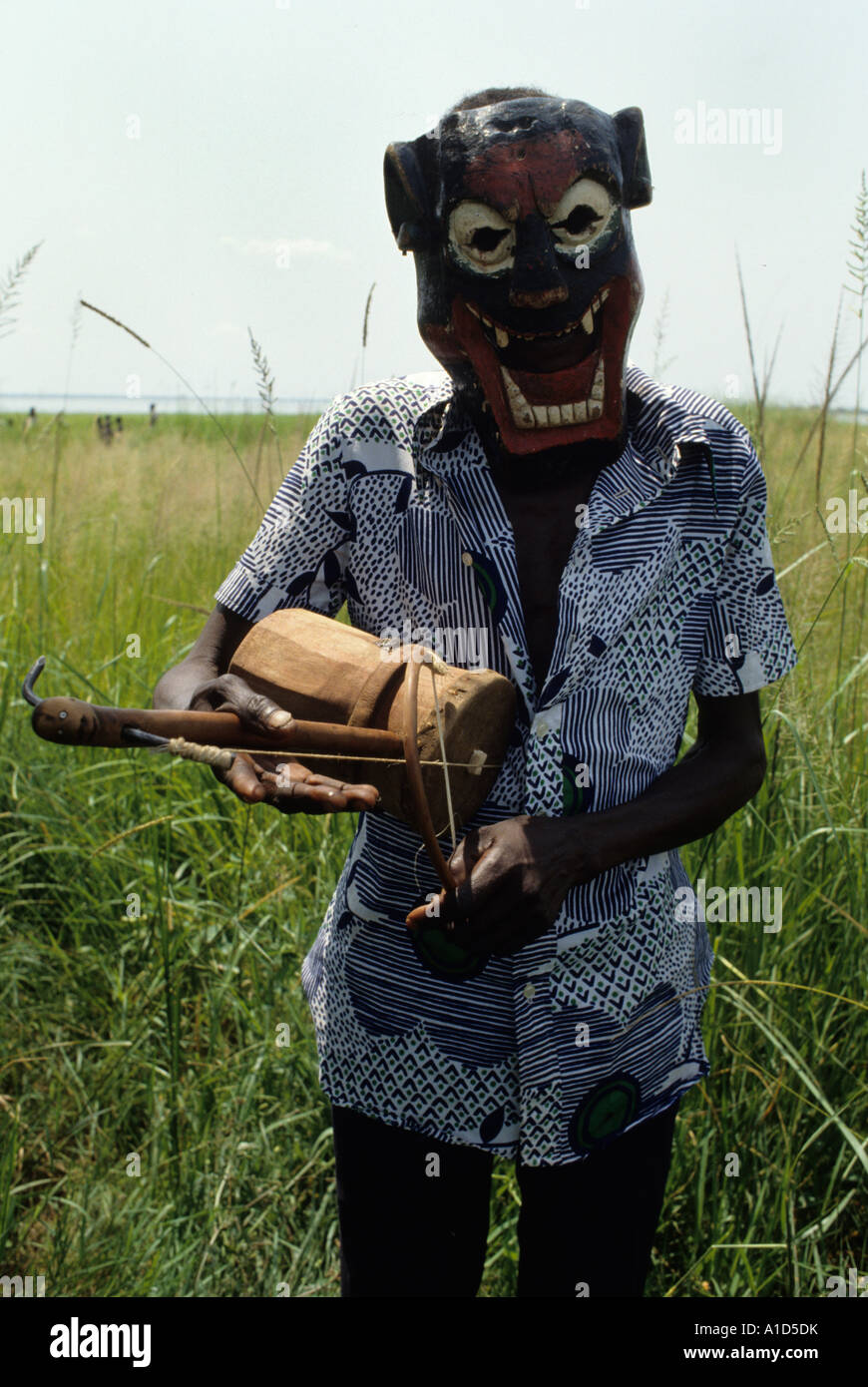 Masked musician with string instrument Stock Photo - Alamy