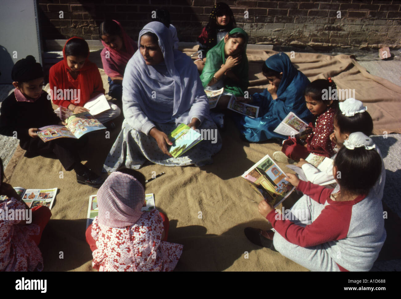 Sikh teacher and pupils at a Sunday school in a south London gurdwara ...
