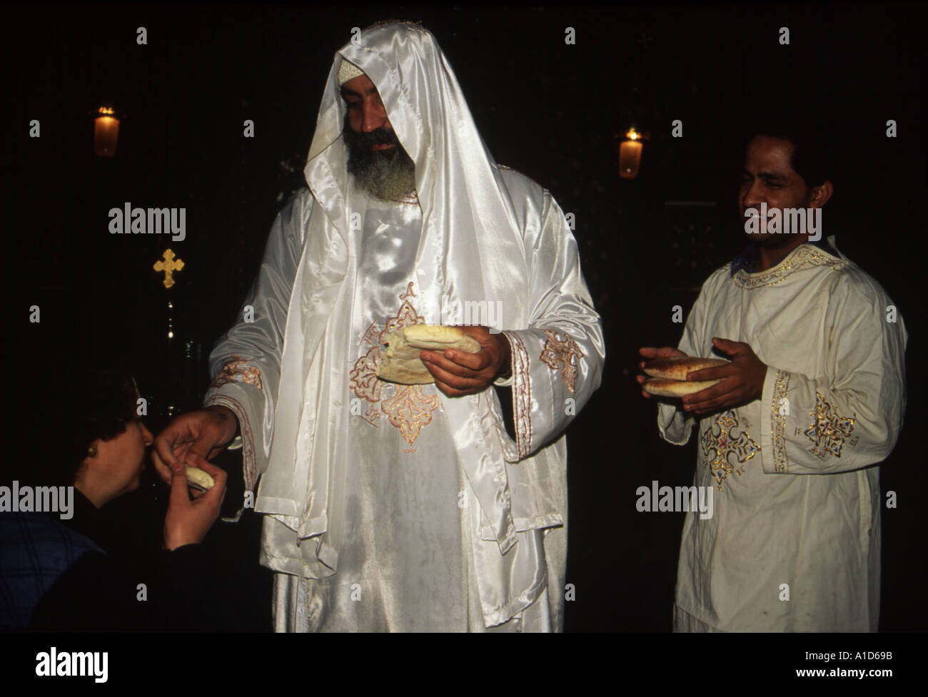 Priest distributing the holy sacraments Coptic Christian Communion in ...